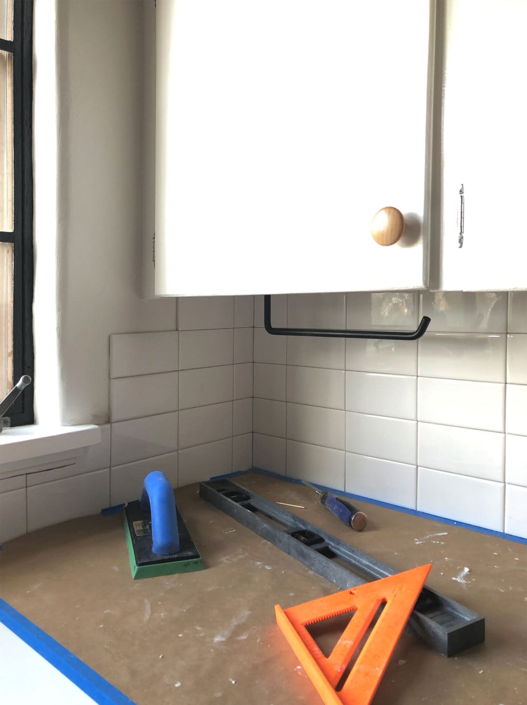Installing a stacked bond subway tile backplash. | Door Sixteen